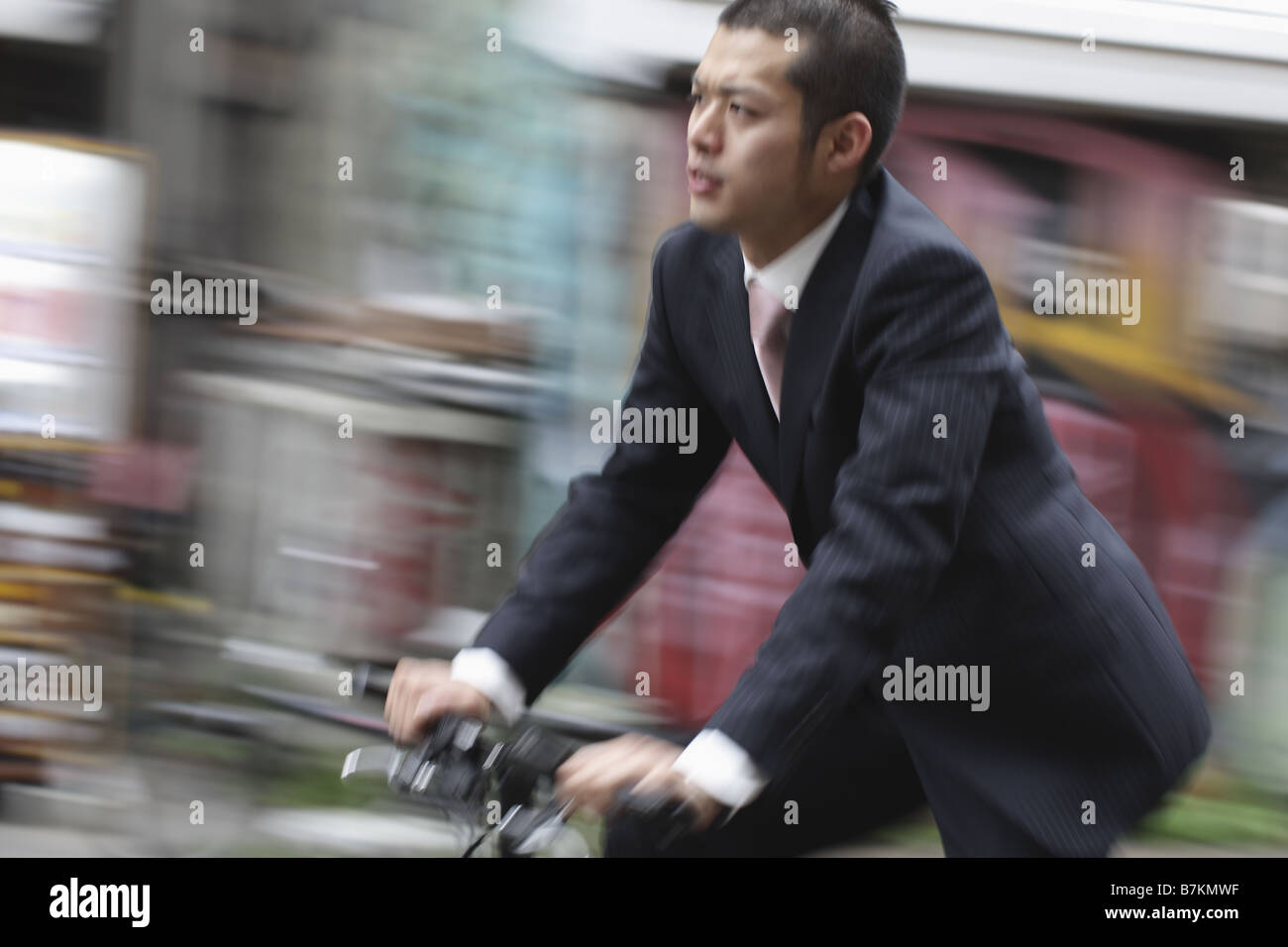 Businessman Riding Bike Stock Photo - Alamy