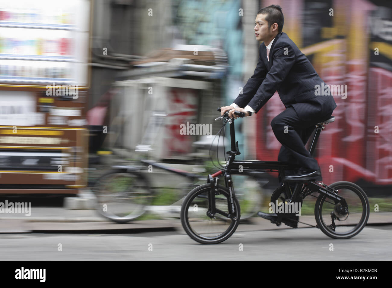 Businessman Riding Bike Stock Photo - Alamy