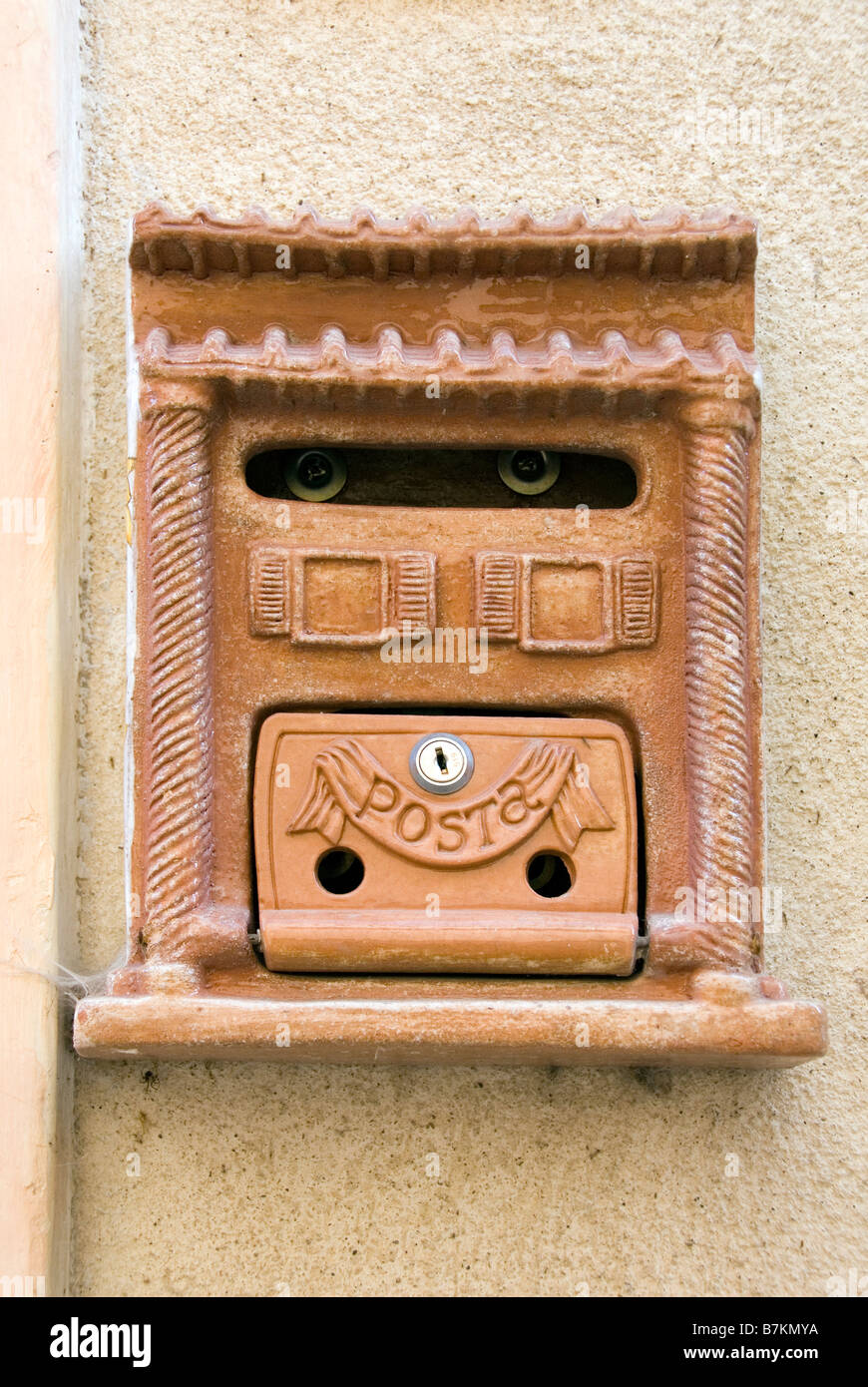 Terracotta postbox in the shape of a face Stock Photo - Alamy