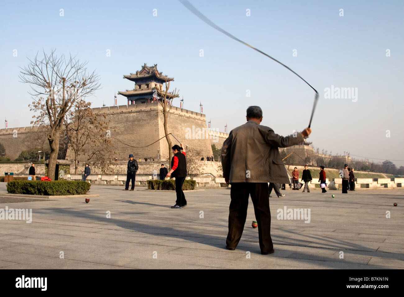 People playing and strolling in the Moat Park a park outside the old ...