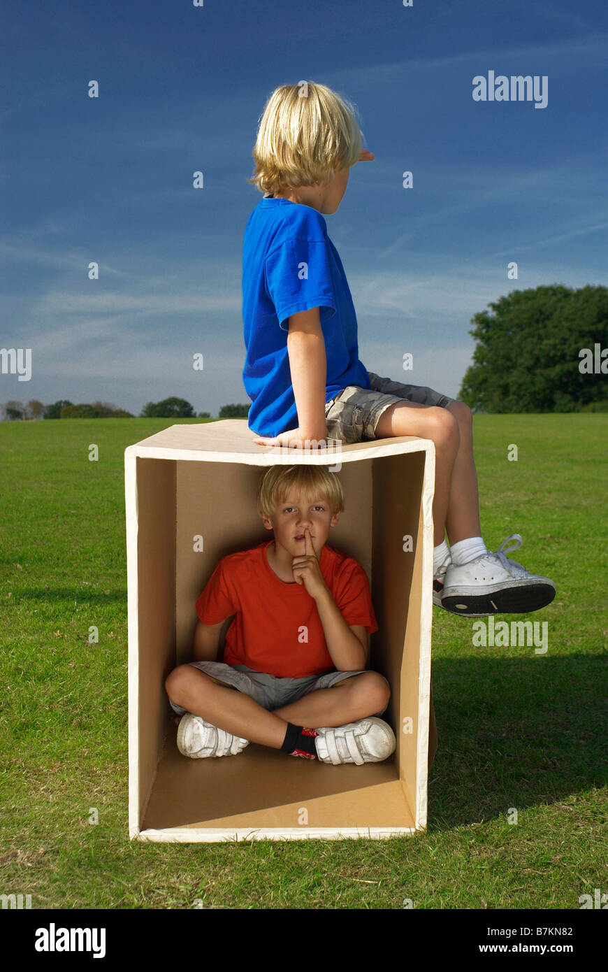 two boys playing with box Stock Photo - Alamy