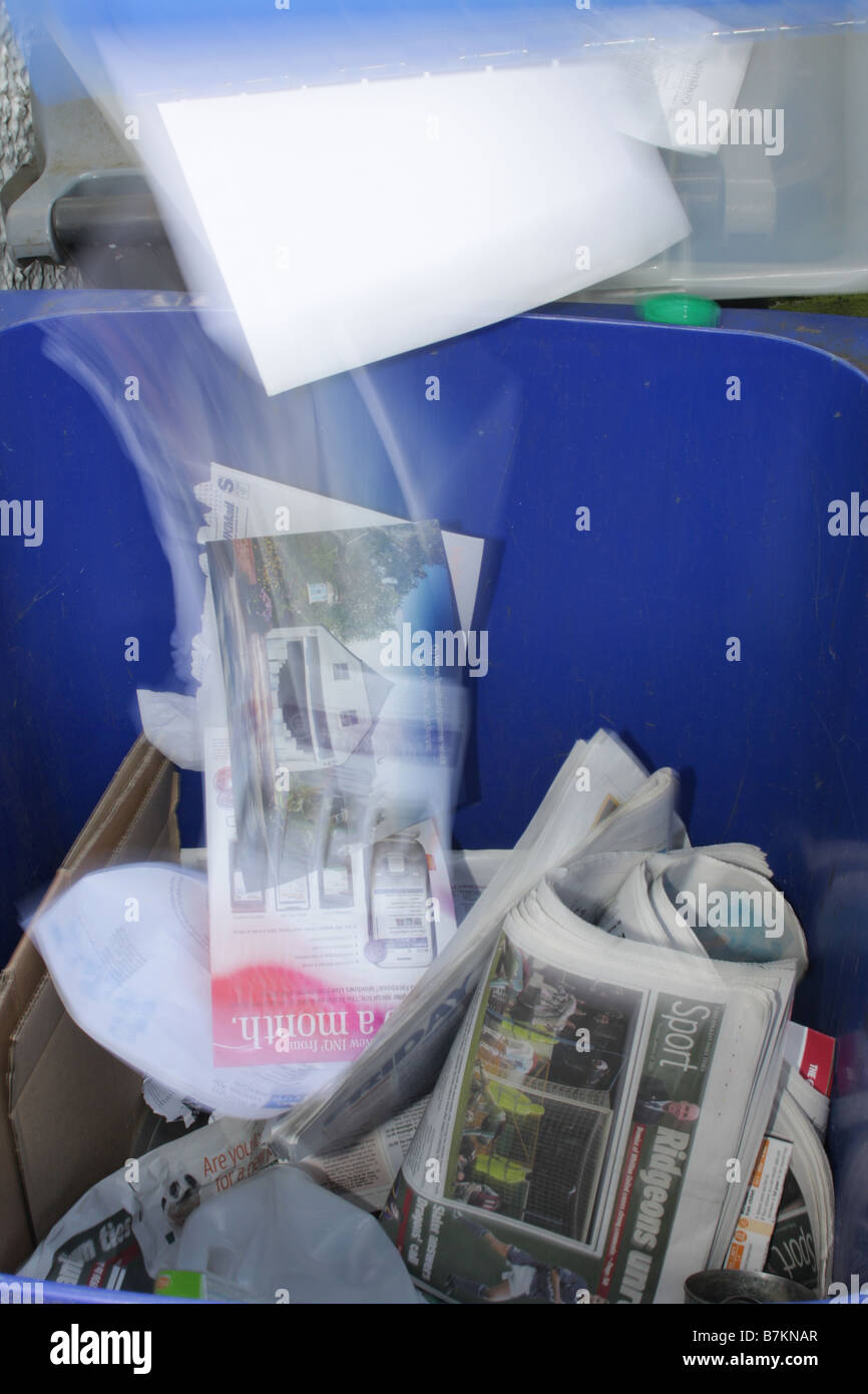 waste paper falling into recycle bin Stock Photo - Alamy