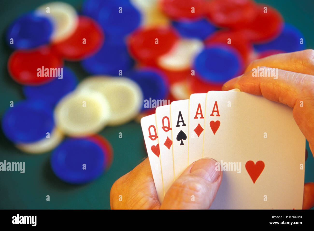 Poker hand showing full house of Aces and Queens Stock Photo - Alamy