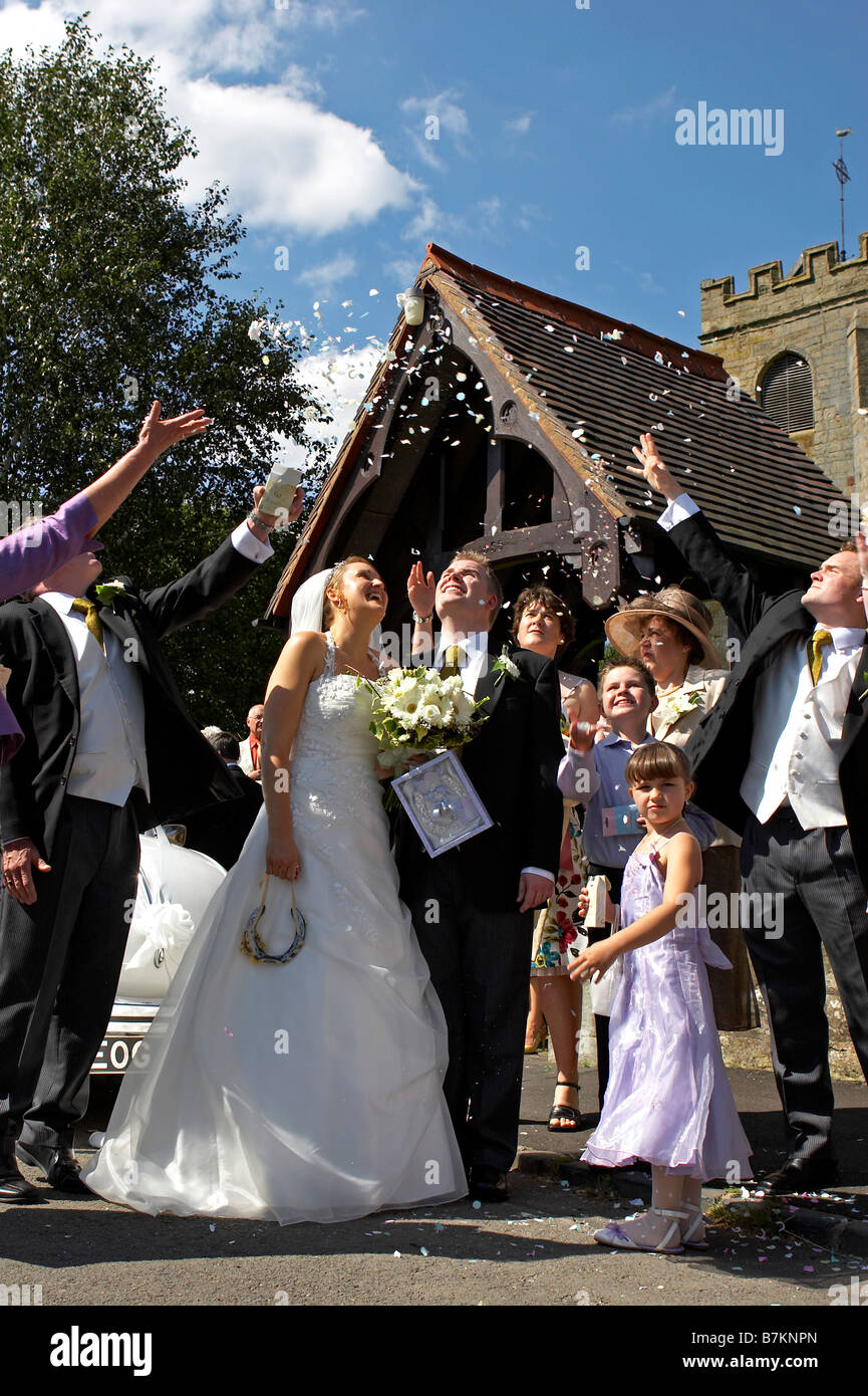 Confetti is thrown over the happy couple after a church wedding in ...