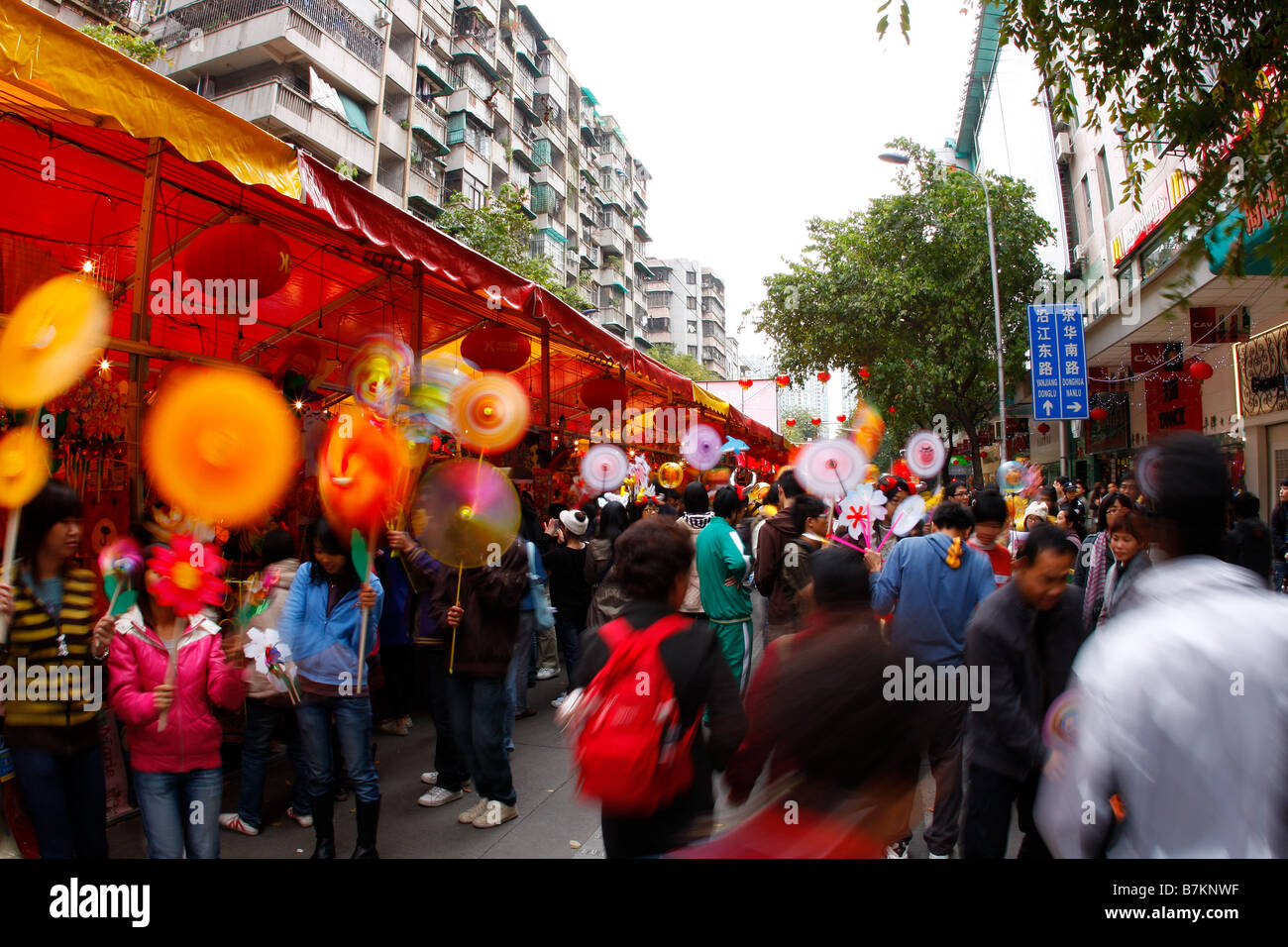 Chinese Students selling traditional lucky pinwheels at Flower market ...
