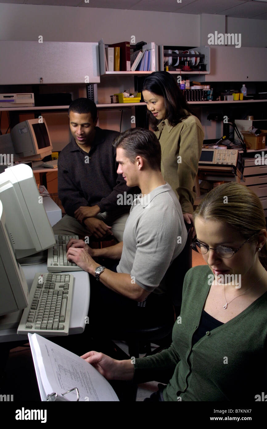 Multicultural employees at computers Stock Photo - Alamy