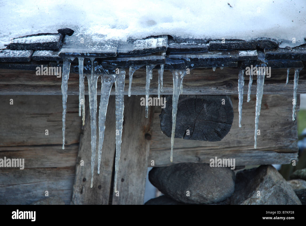 ice hanging from roof of old fashioned Austrian shed in winter Stock ...