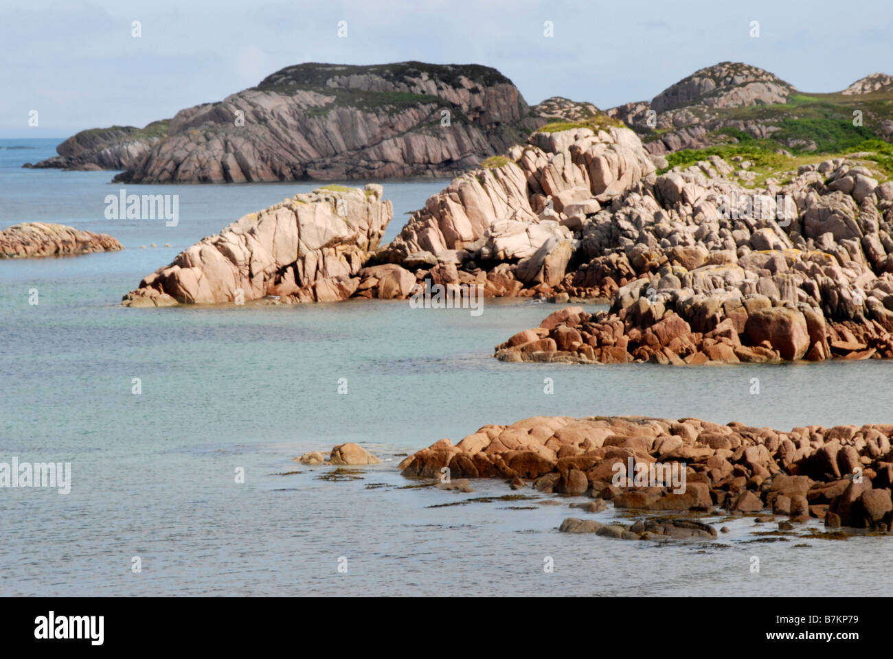 Pink granite rocks on the shoreline at Fionnphort on Isle of Mull ...