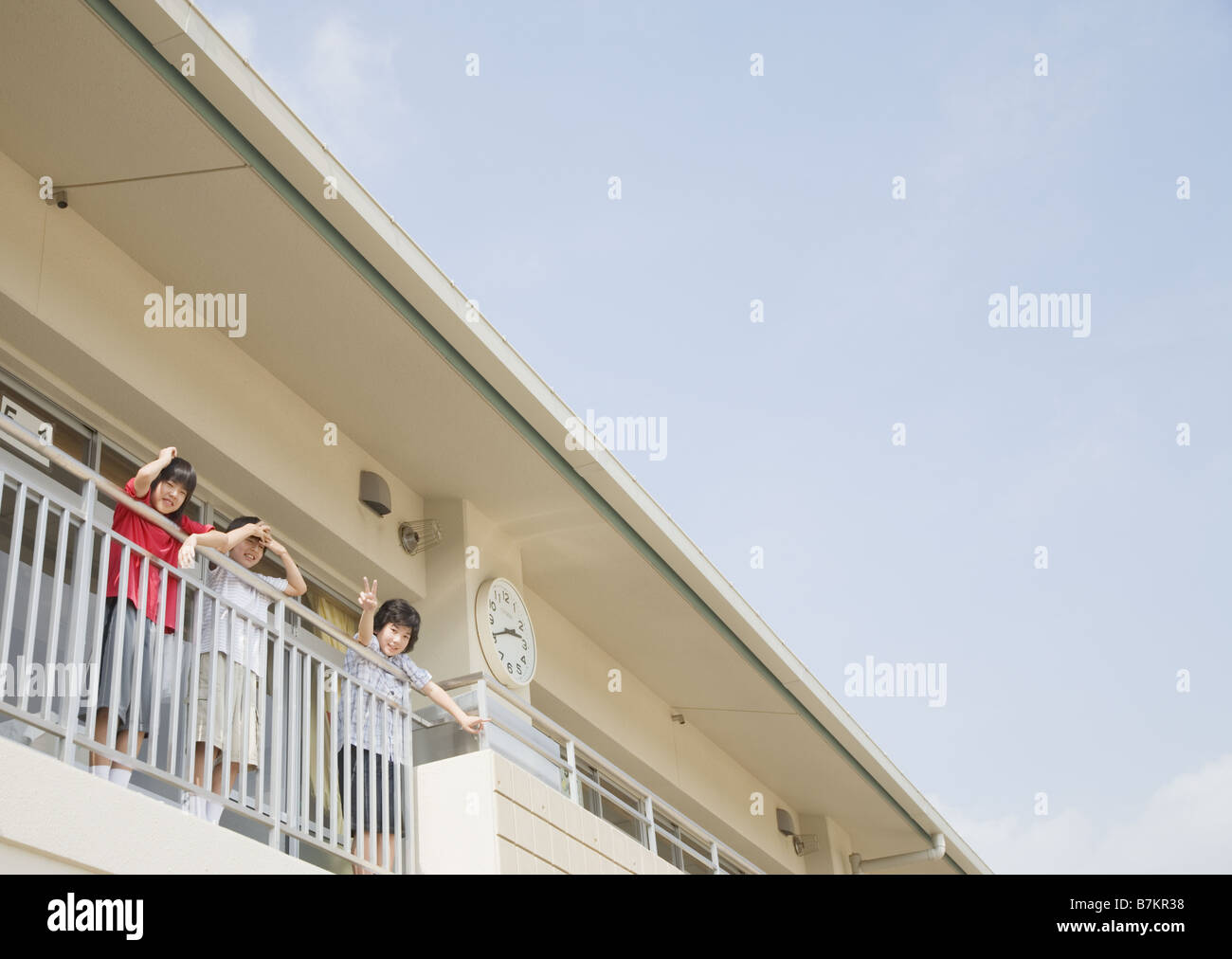 Elementary school students standing on balcony of school building Stock ...