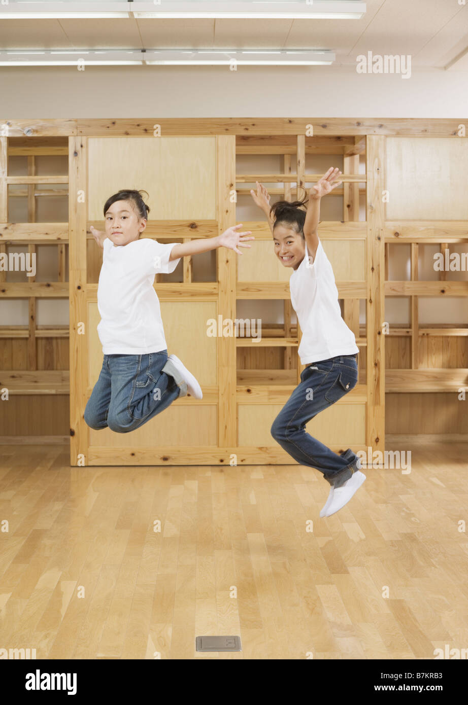 Elementary school students jumping Stock Photo - Alamy