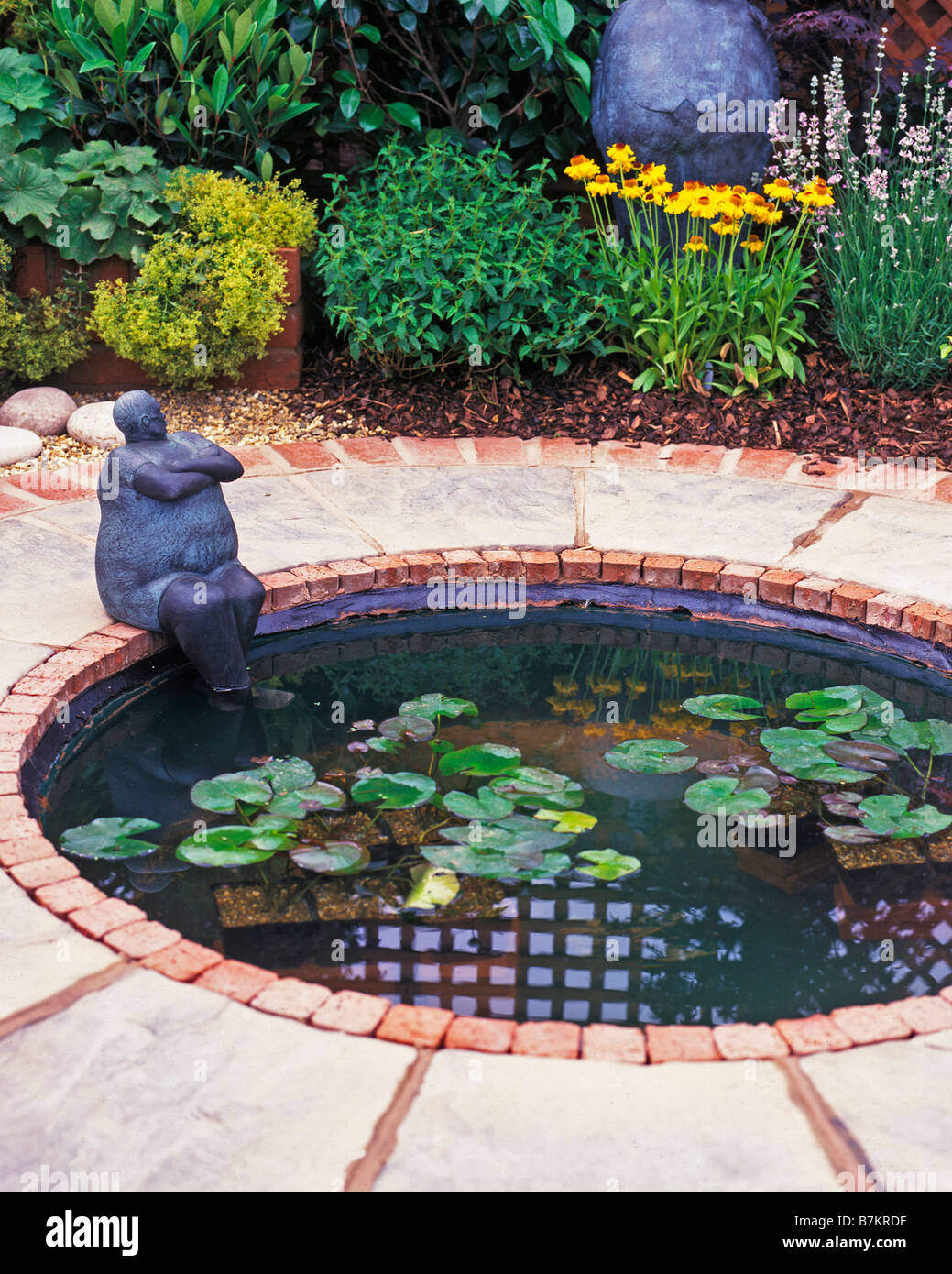 PATIO FEATURE CONSISTING OF SMALL ROUND POND WITH WATER LILIES Stock ...