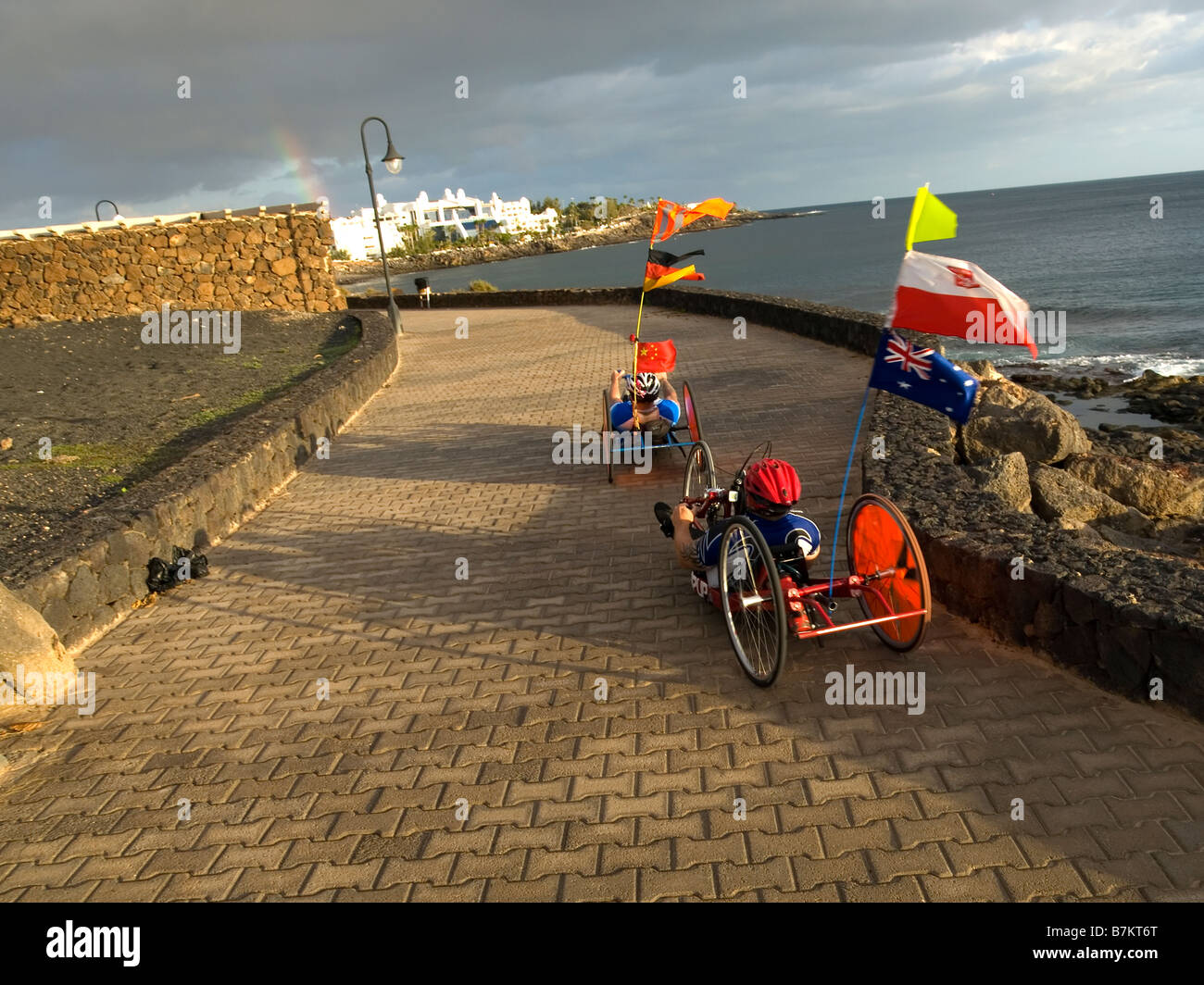 Two cyclists on hand driven recumbent tricycles on the promenade at ...