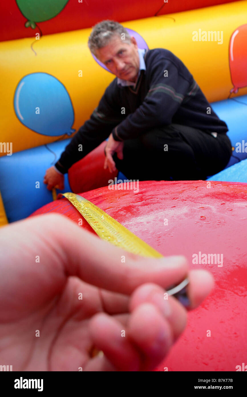 An inspector for PIPA checks an inflatable castle meets regulations ...