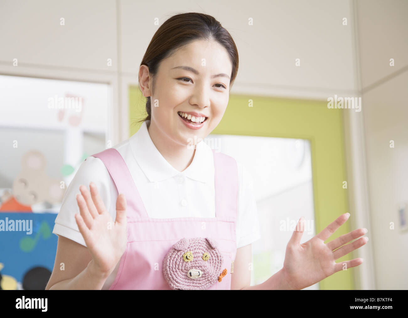 A smiling childminder Stock Photo - Alamy