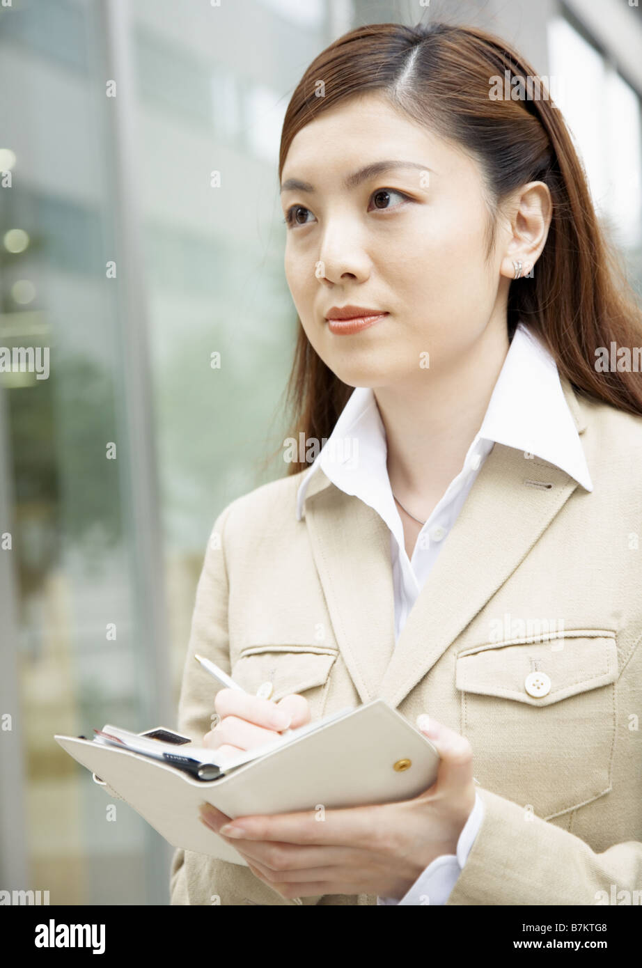 A woman journalist taking a note Stock Photo - Alamy