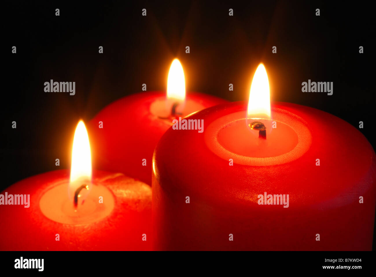 Candle A burning flame of a candle of red color Stock Photo - Alamy