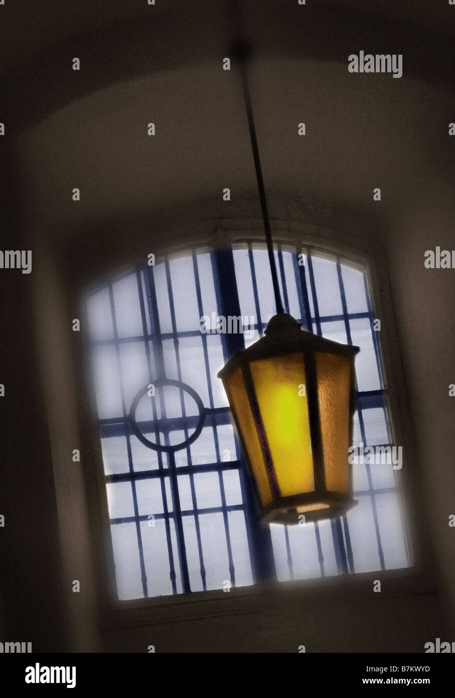 bright single light shining in dull room with barred window Stock Photo ...