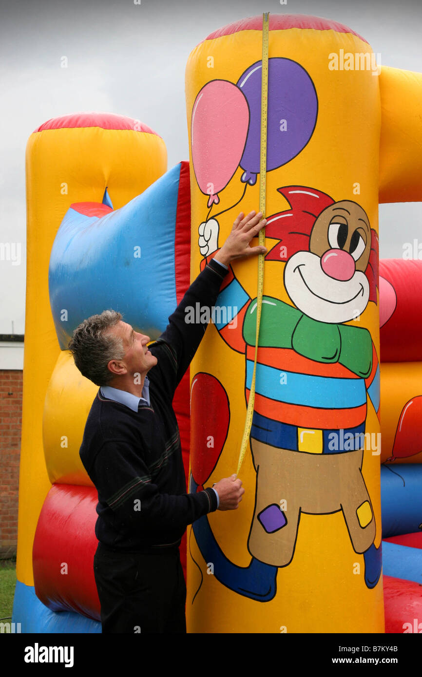An inspector for PIPA checks an inflatable castle meets regulations ...