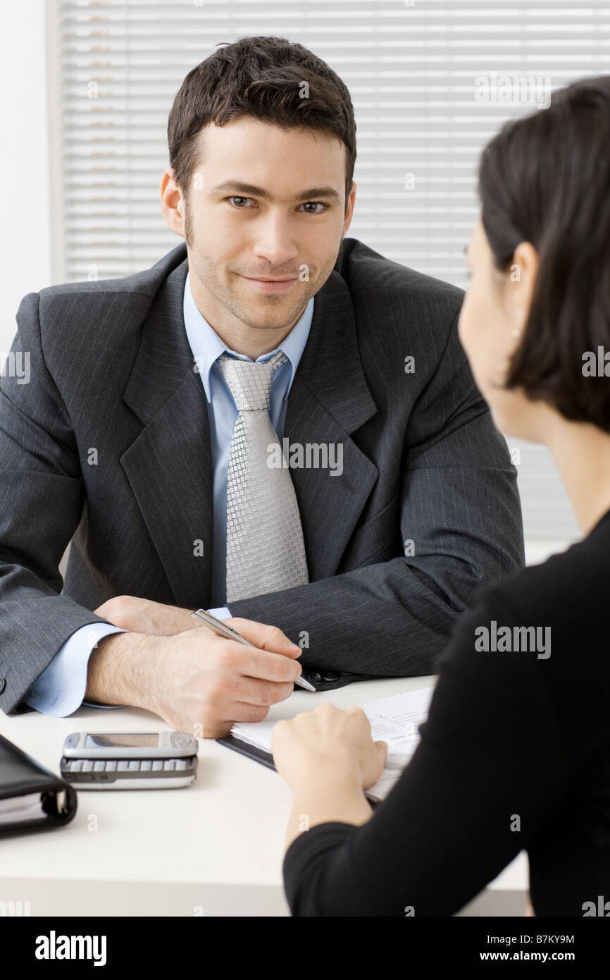 Happy young adviser businessman consulting at office smiling Stock ...