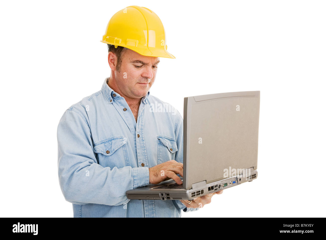 Construction engineer using his laptop computer on the job Isolated on ...