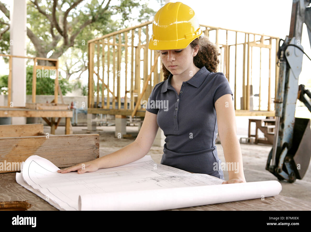A female engineering student on the job site reviewing blueprints Stock ...