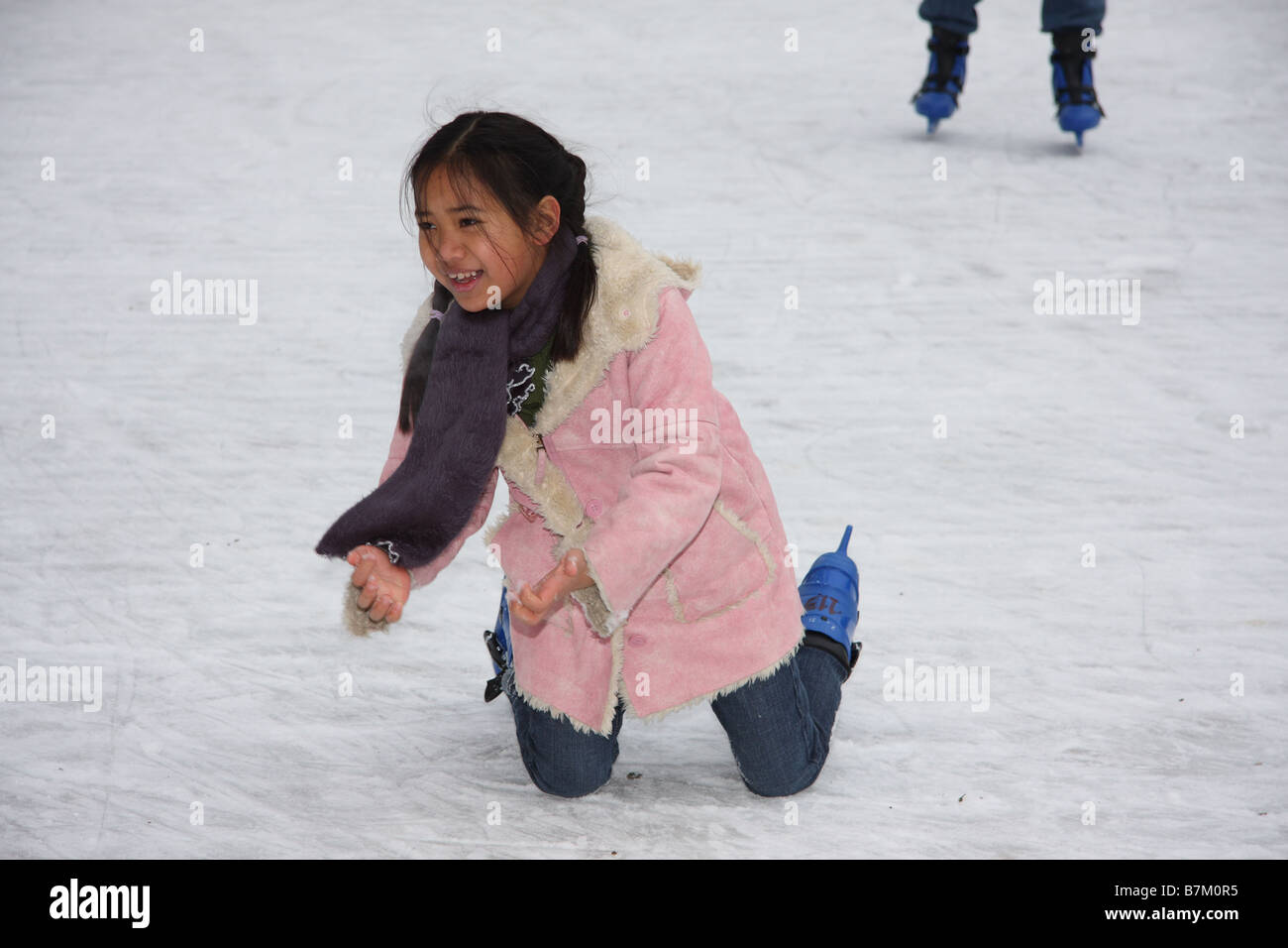 slip fall chinese girl ice skating skaters rink open air cold winter ...