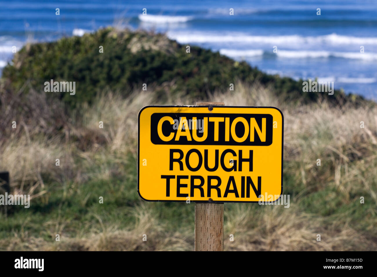 Caution sign indicating rough terrain on the Oregon coast Stock Photo ...
