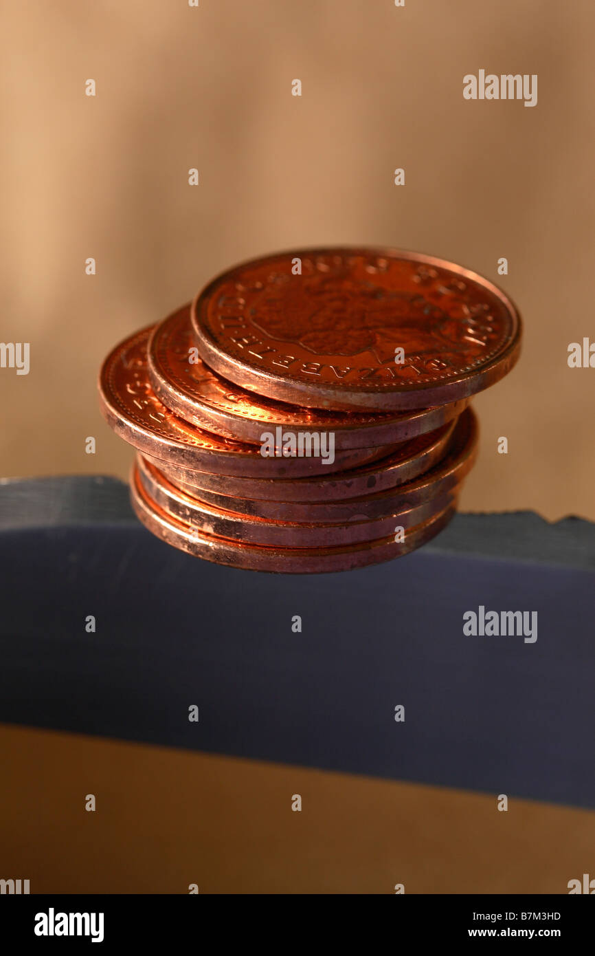 Pile stack heap of British 1p 1 penny pennies money coin balanced on a ...