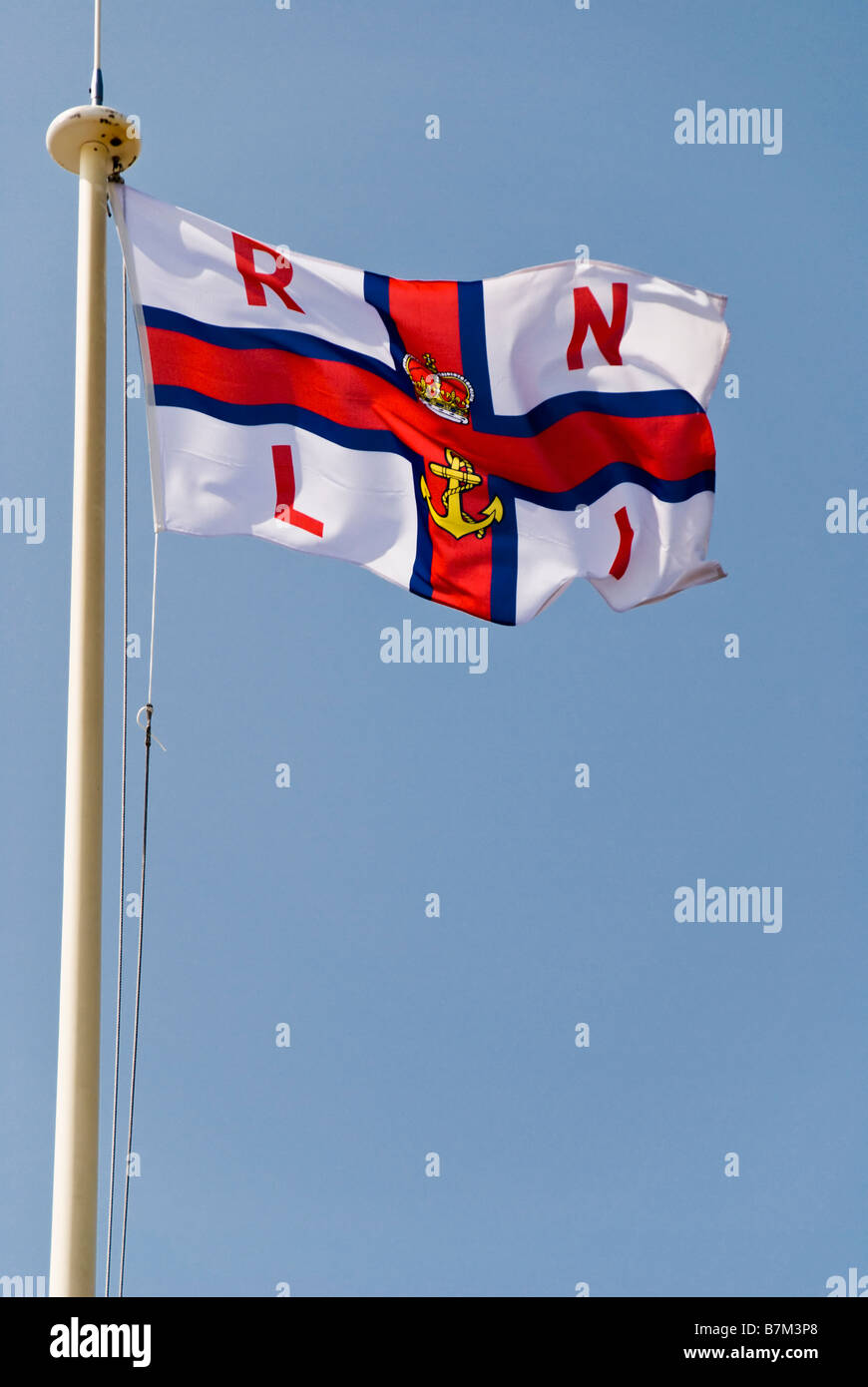 A RNLI flag blowing on a blue sky background Stock Photo - Alamy