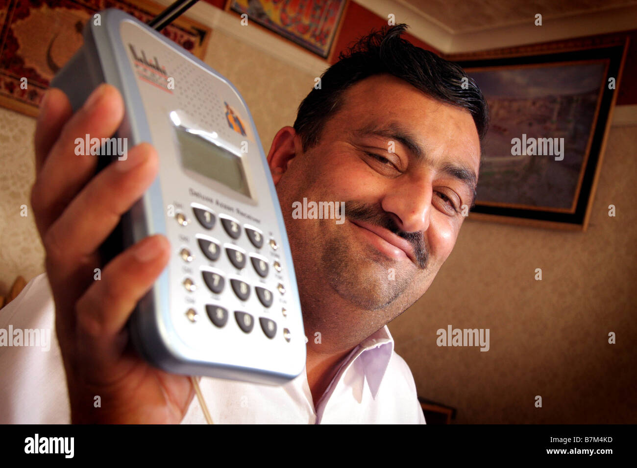 Muslim man with his reciever for the muslim prayer call Stock Photo - Alamy