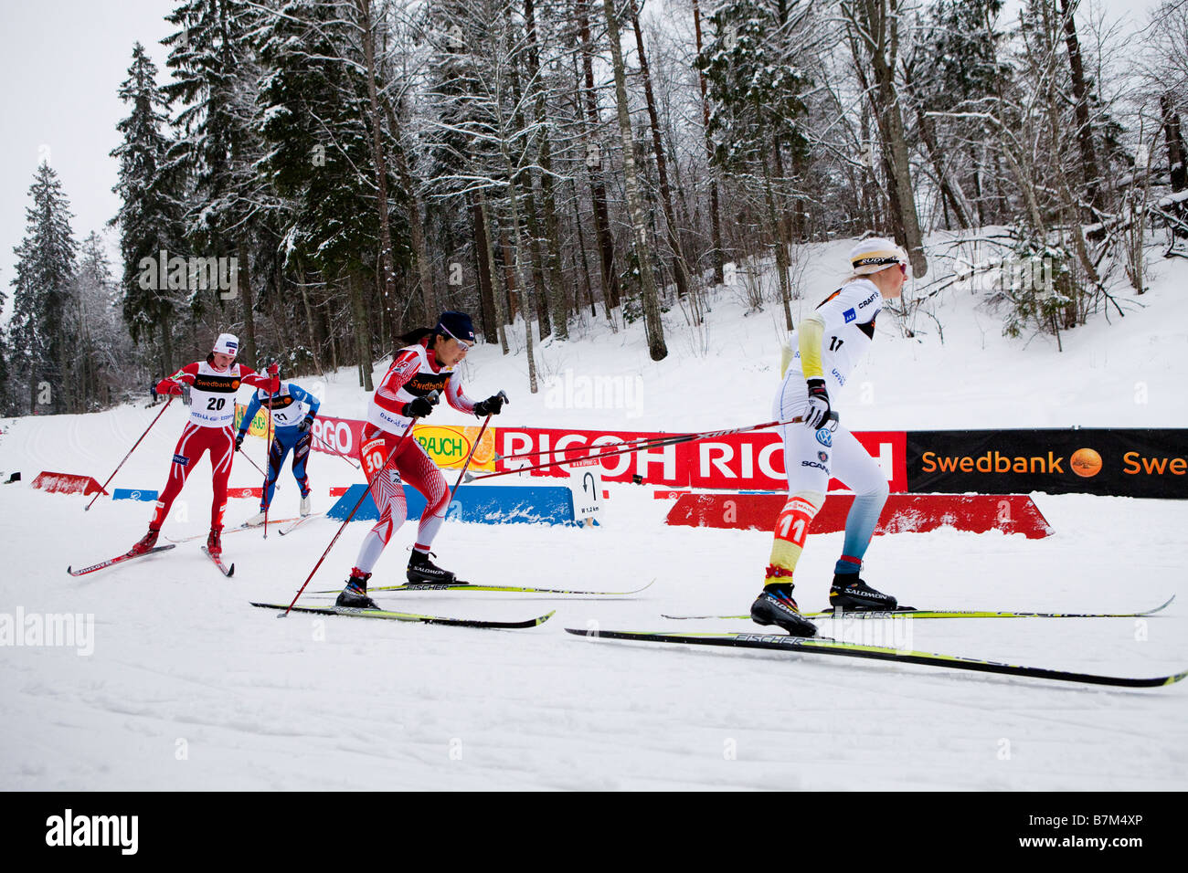 female cross country ski racers accelerating from a turn, Anna Olsson ...