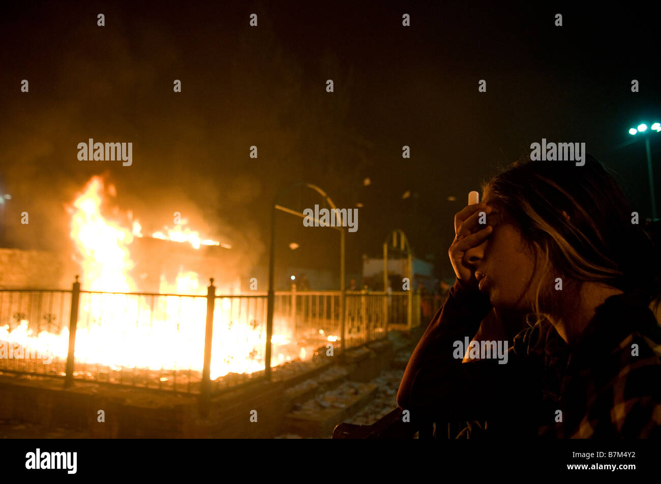 A Sephardic Jewish woman praying next to a large furnace at the ...
