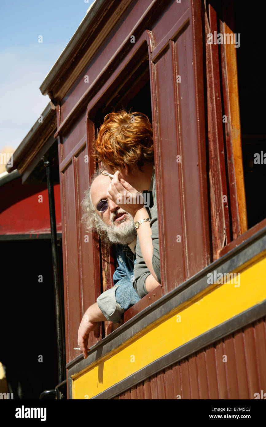 Man and woman in conversation and smoking on the Red Lizard train ...