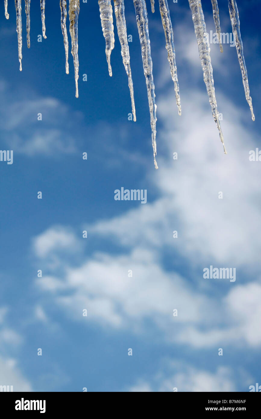 Hanging icicles on the gutter from house blurred blurry blur background ...