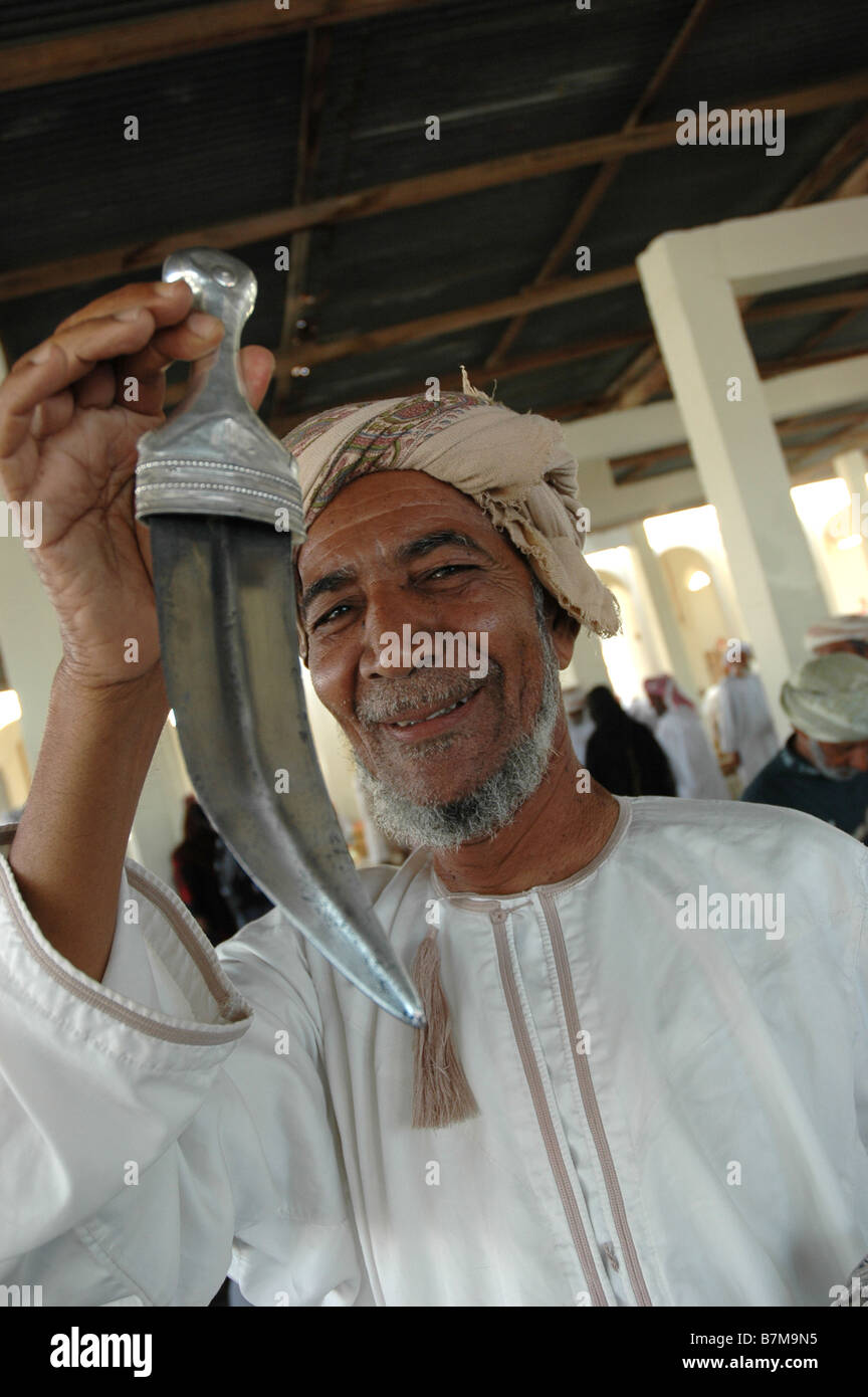 Local Omani man wearing a traditional dishdasha and turban poses for ...