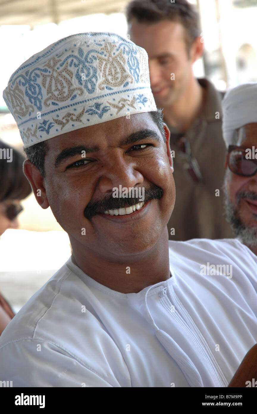 Local Omani man wearing a traditional dishdasha poses for the camera in ...