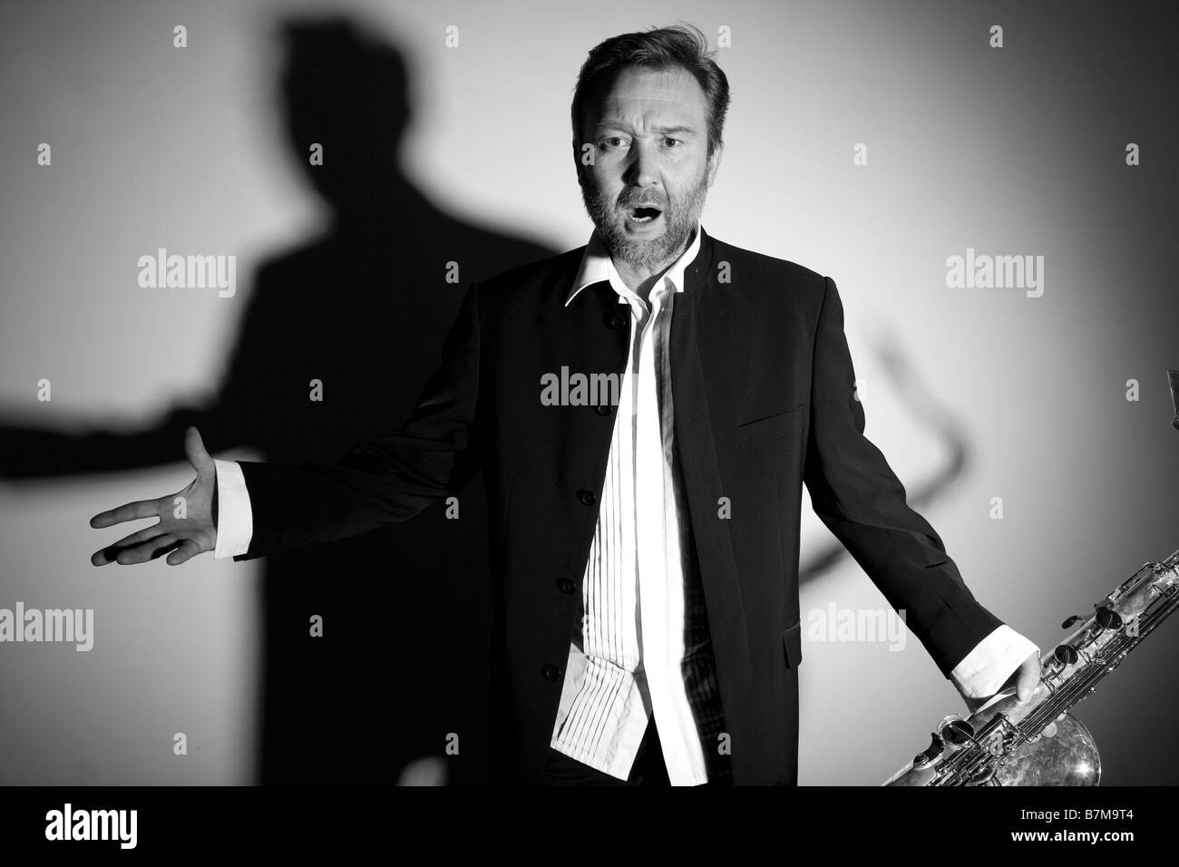 angry musician holding saxophone in black and white Stock Photo - Alamy