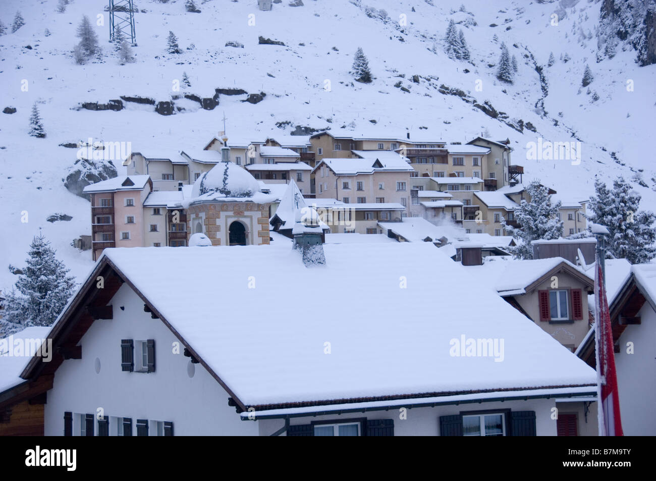 Snow covered houses in the village of Bivio along the Julier pass ...