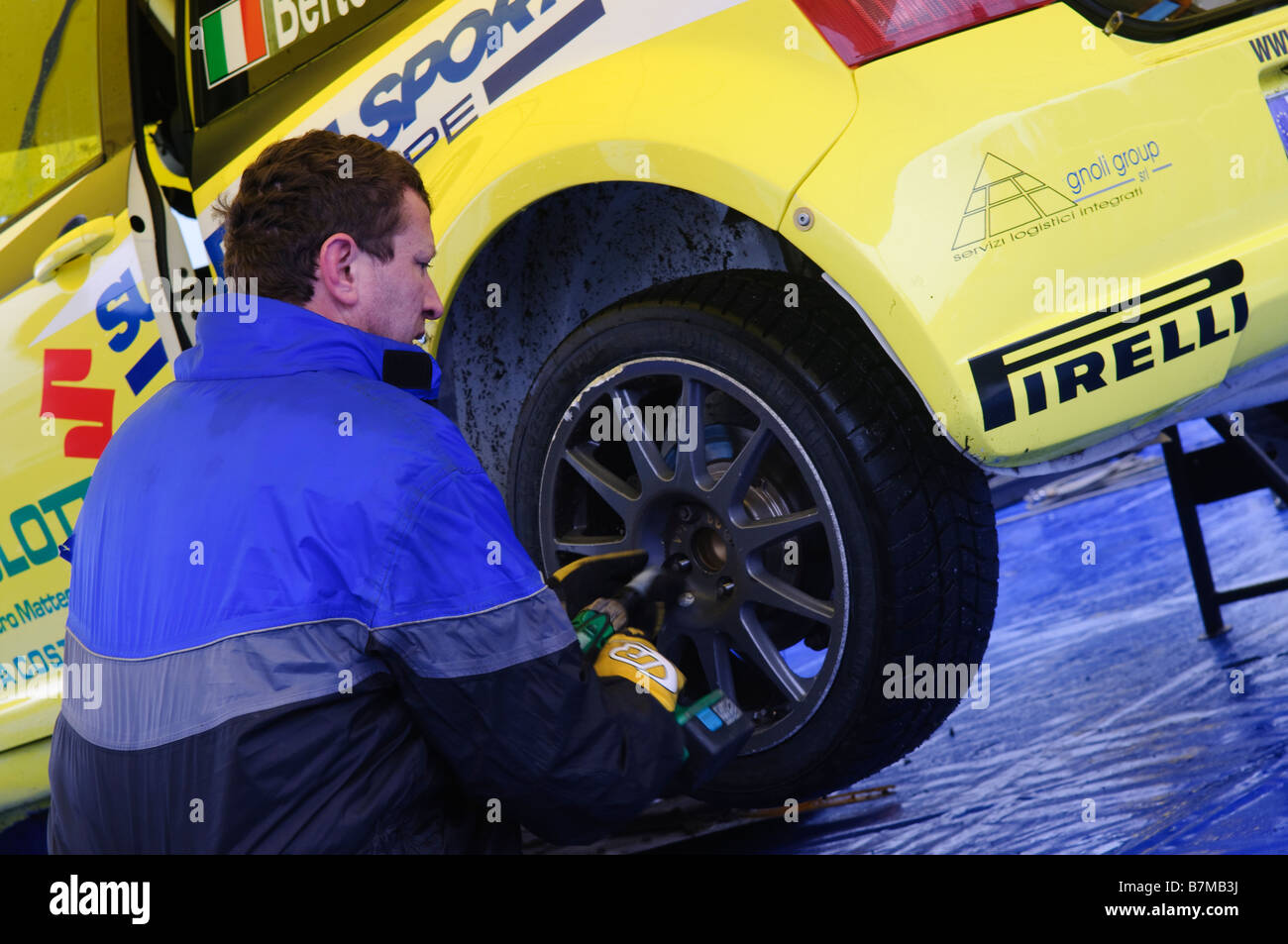 Rally car mechanic about to remove rear wheel of car using at Rally ...