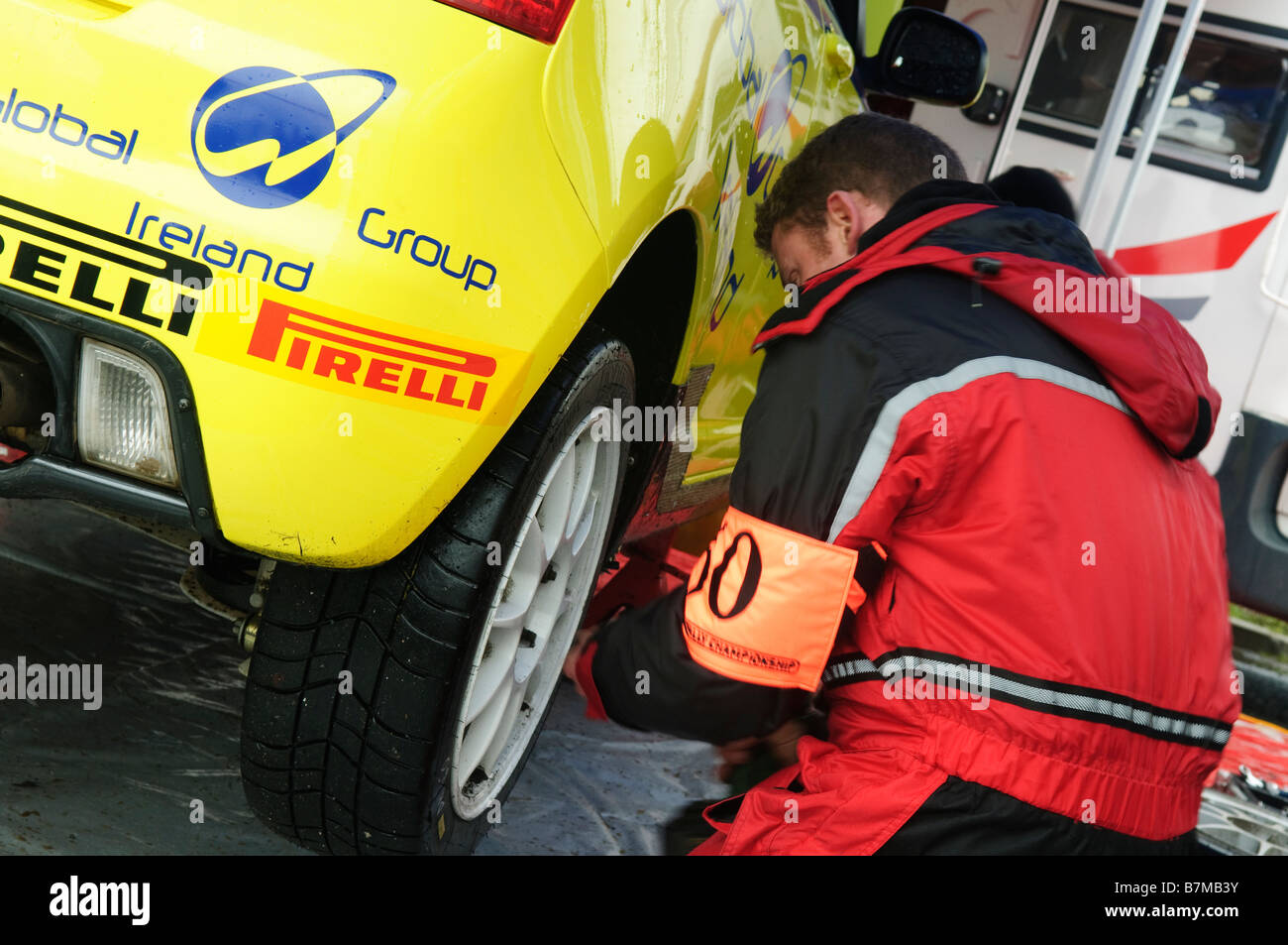 Rally car mechanic about to remove rear wheel of car at Rally Ireland ...