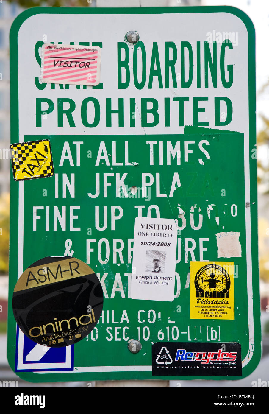 Street sign at JFK Plaza defaced with stickers Stock Photo - Alamy