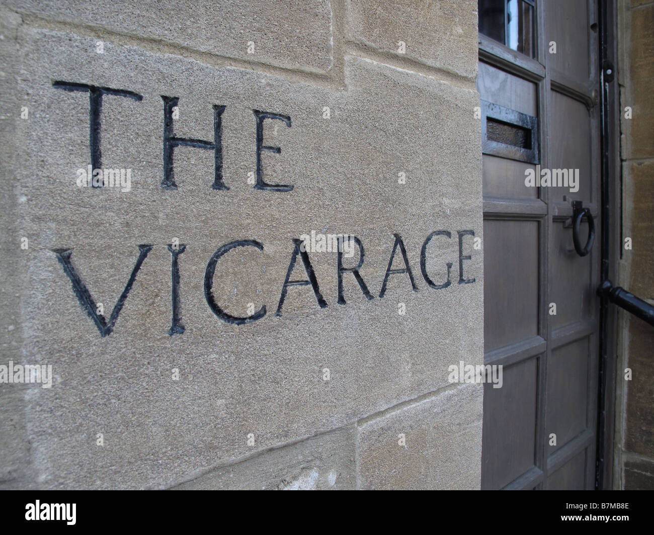 A carved Vicarage house sign Stock Photo - Alamy