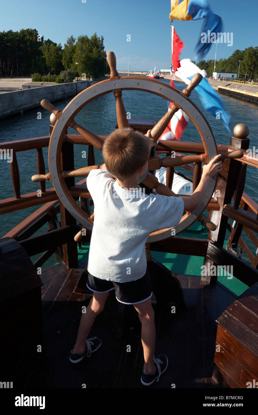 The young helmsman in a boat fishing Stock Photo - Alamy