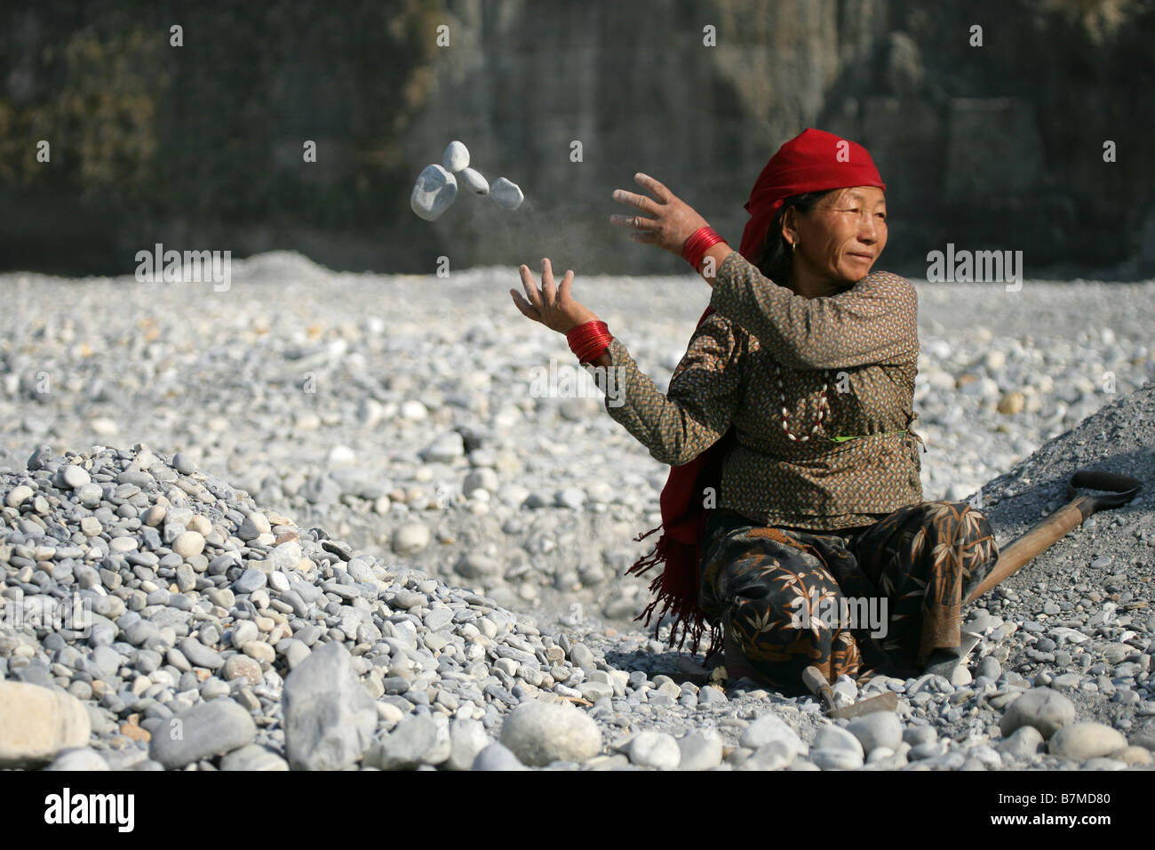 Old Lady grading stone Stock Photo - Alamy