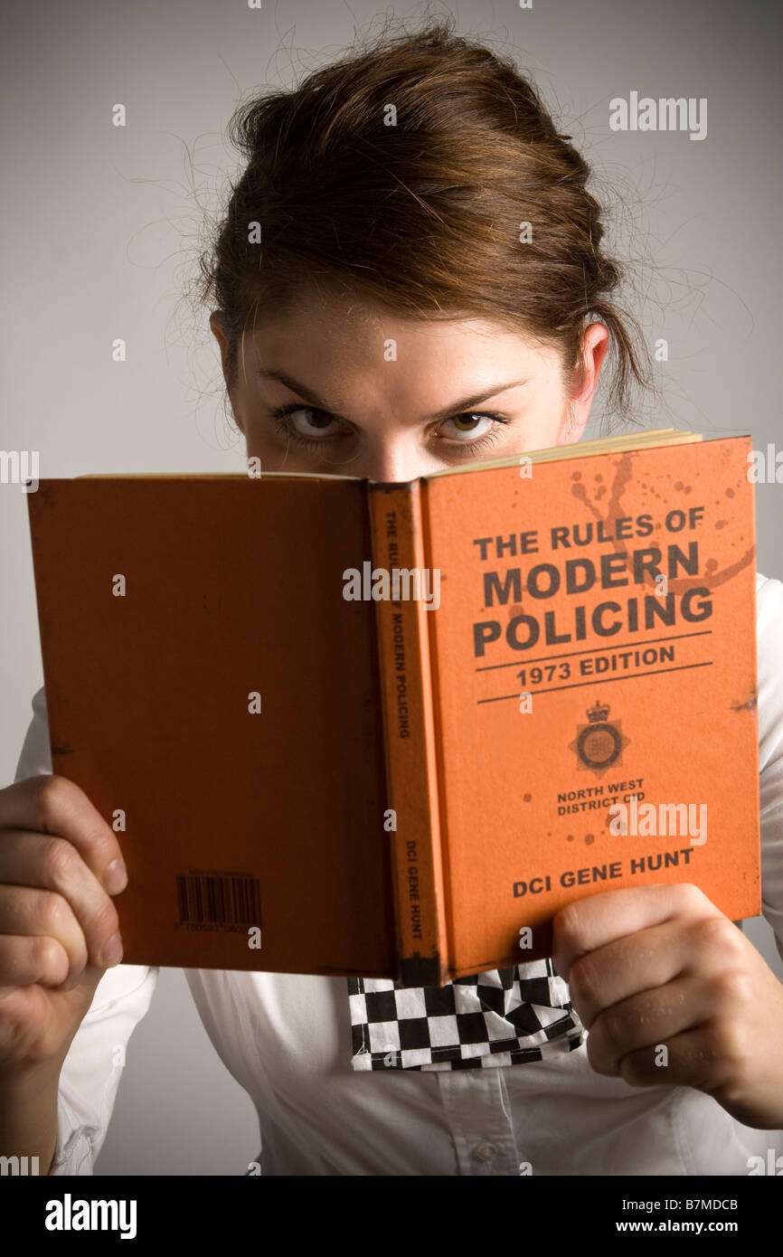 Police woman reading the rules of modern policing 1973 edition by DCI ...