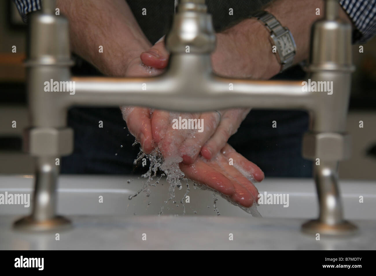 A man washing his hands Stock Photo - Alamy