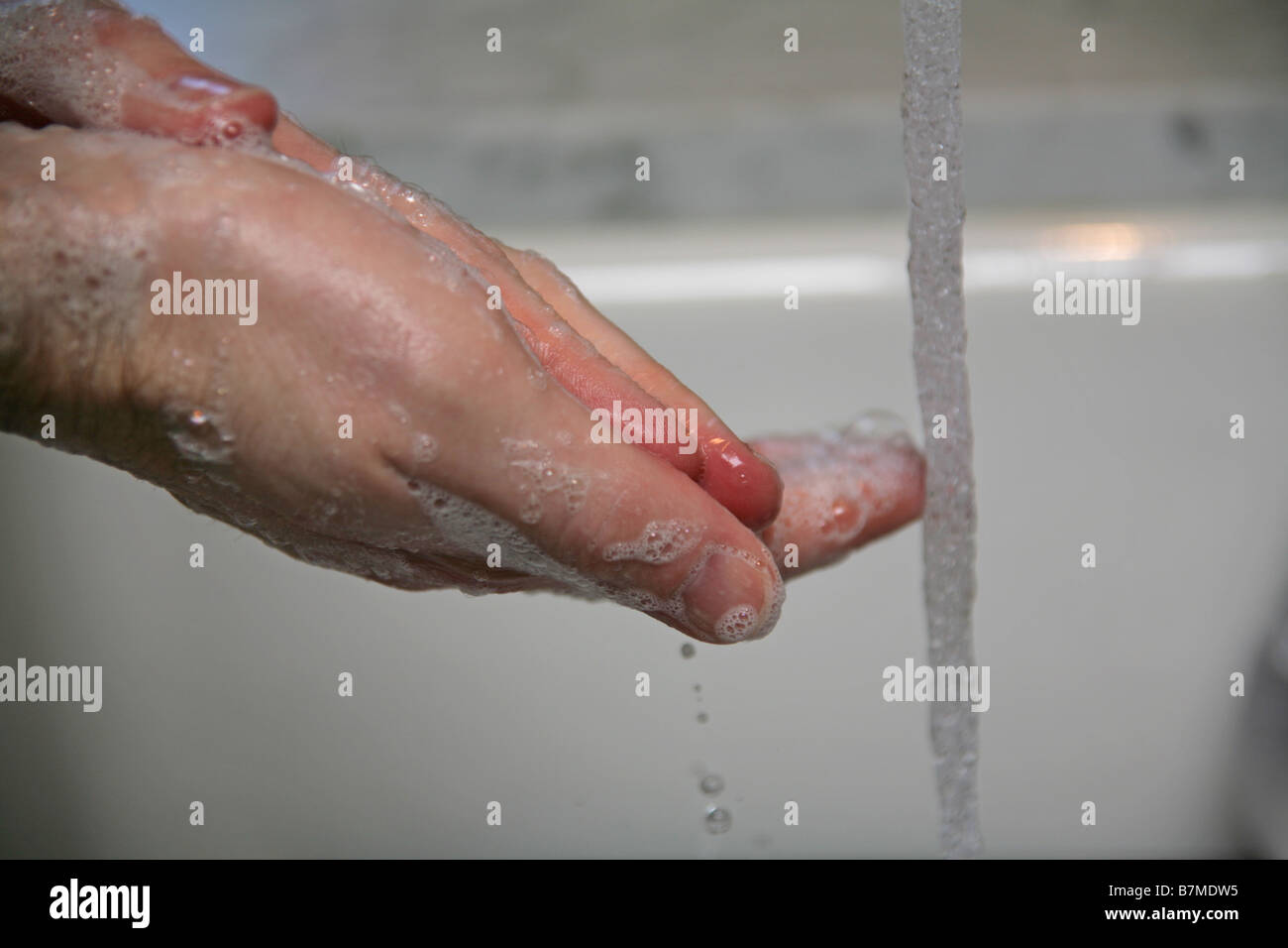 A man washing his hands Stock Photo - Alamy