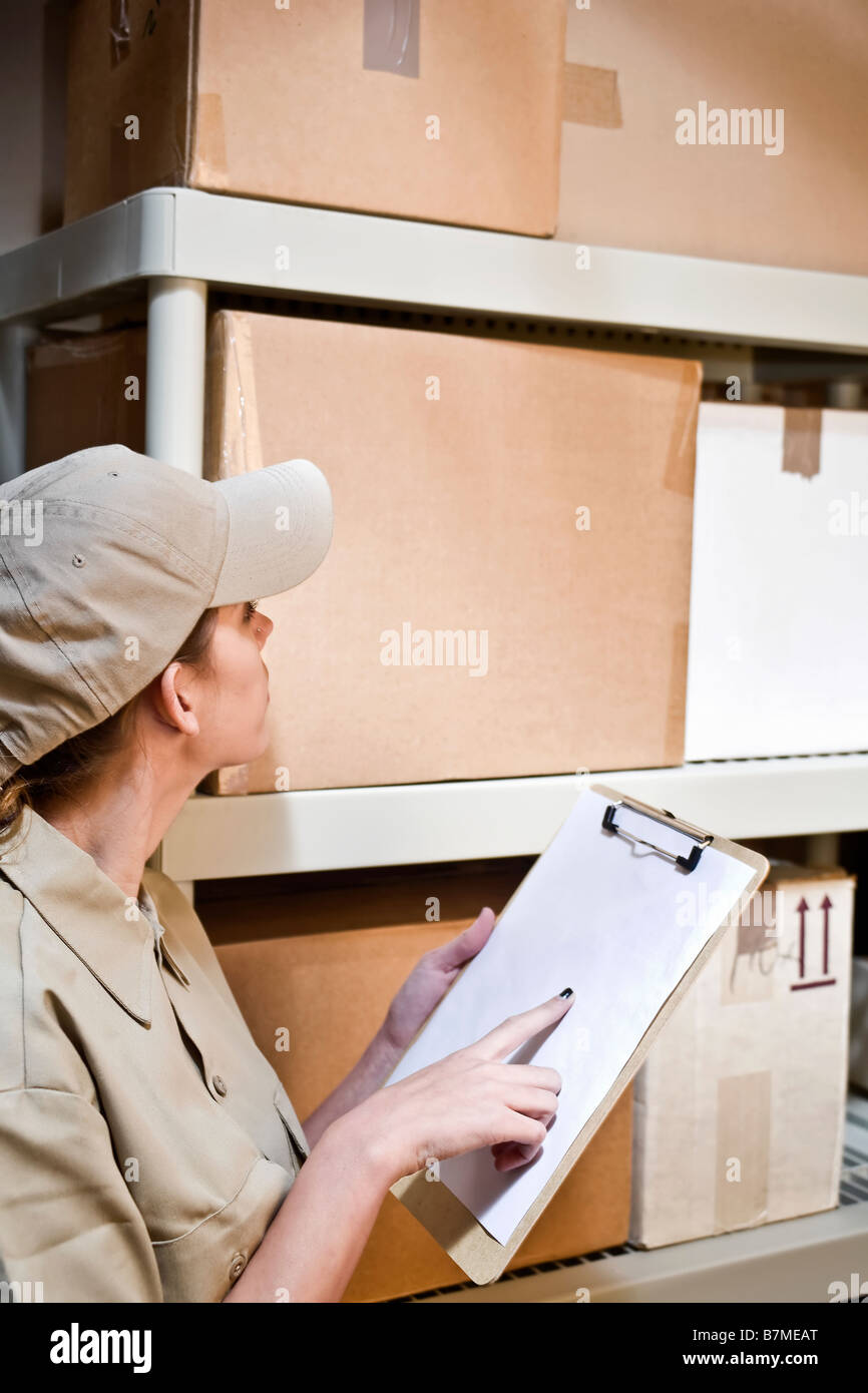 A young warehouse worker taking inventory Stock Photo - Alamy
