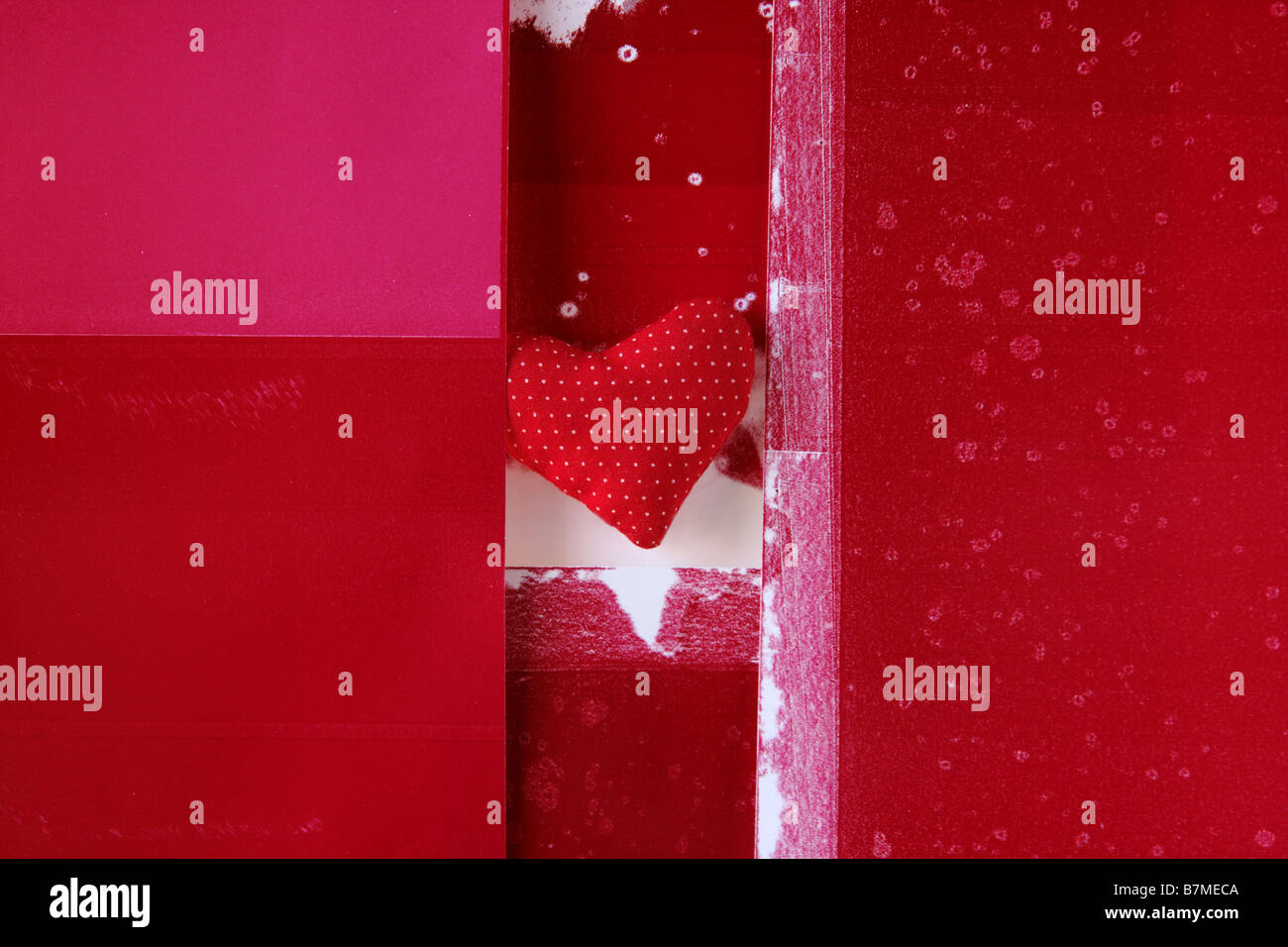 red fabric heart on a red, pink and white background Stock Photo - Alamy