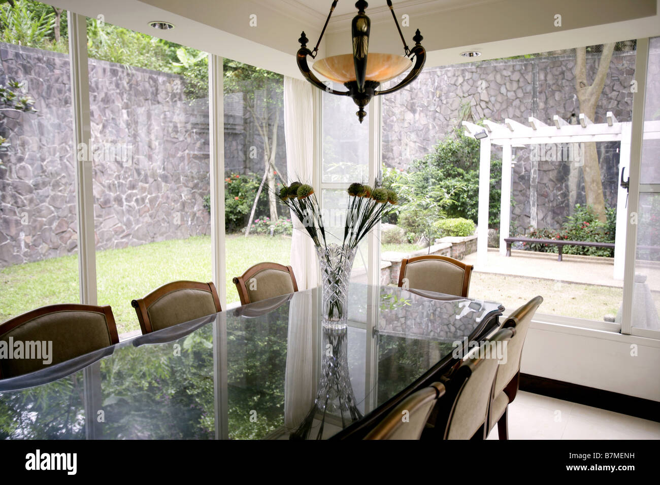 Dining room with garden view outside of window Stock Photo - Alamy